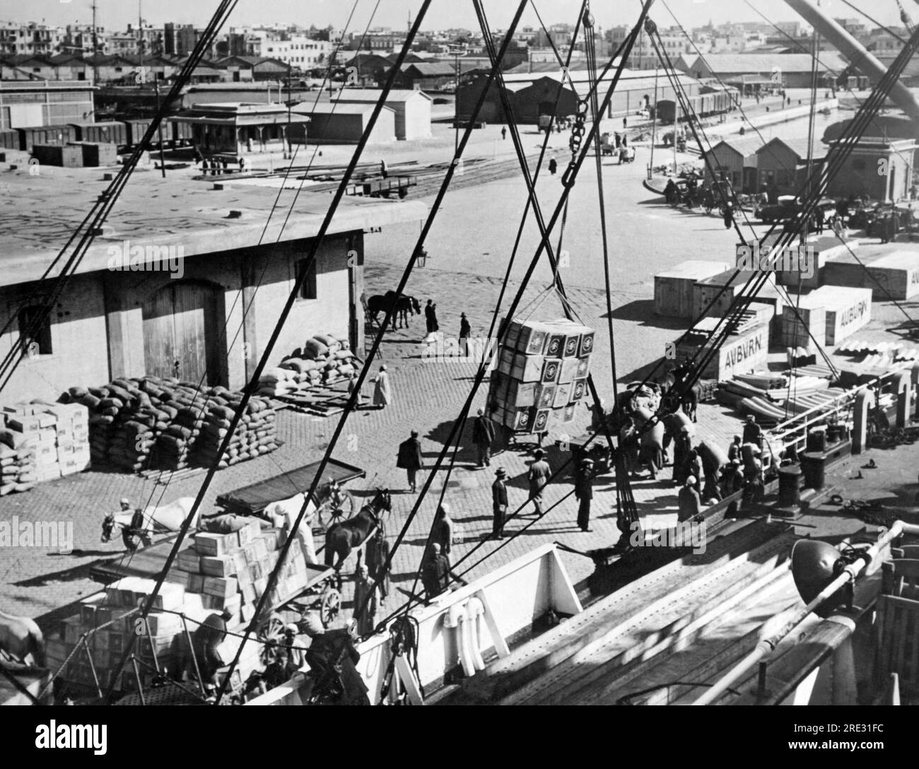 Alexandria, Egypt: c. 1930 A view of the cargo and shipping industry at ...