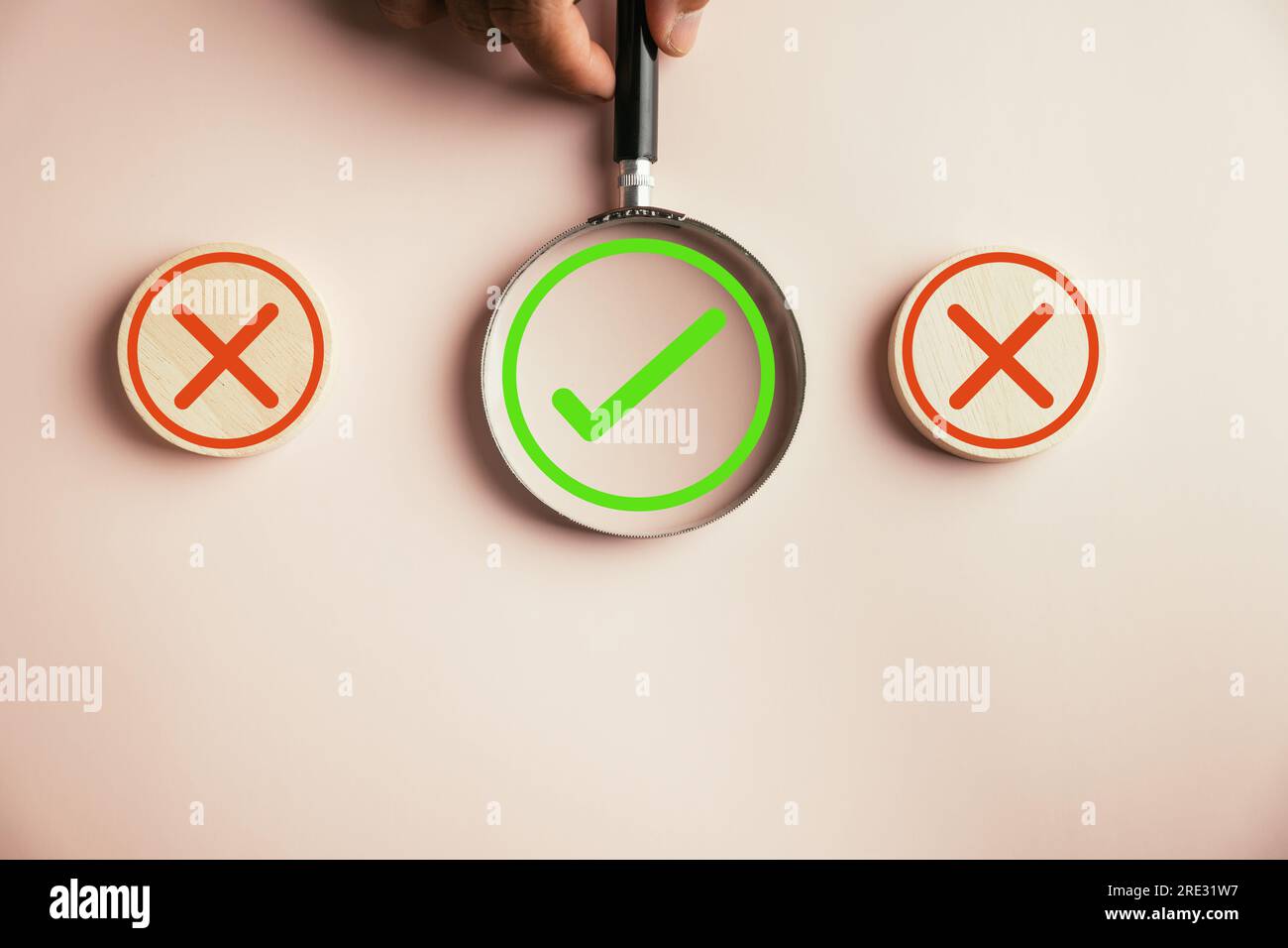 magnifying glass enlarges the correct or check mark Stock Photo - Alamy