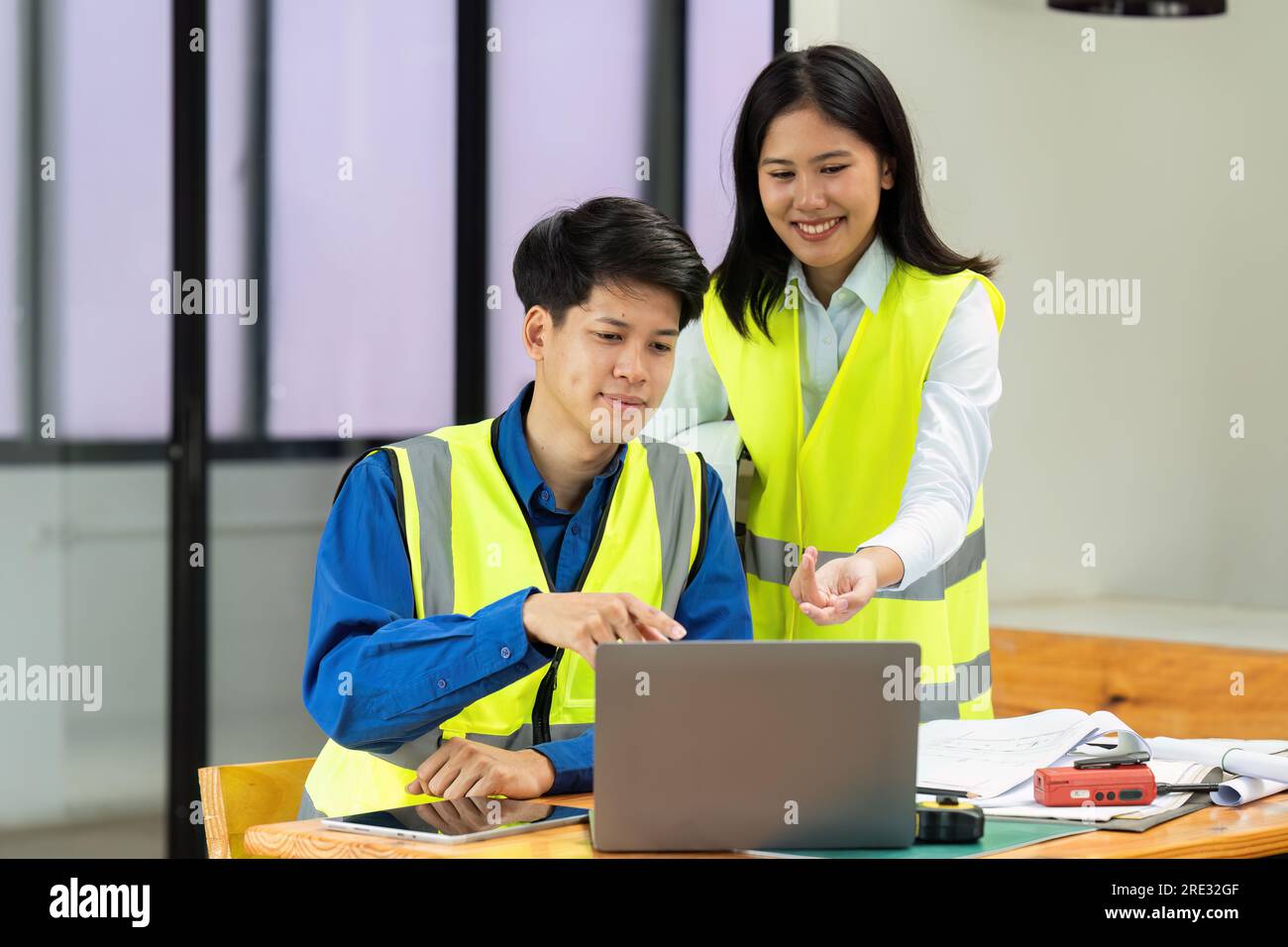 Civil engineers and architects discuss project construction together on ...