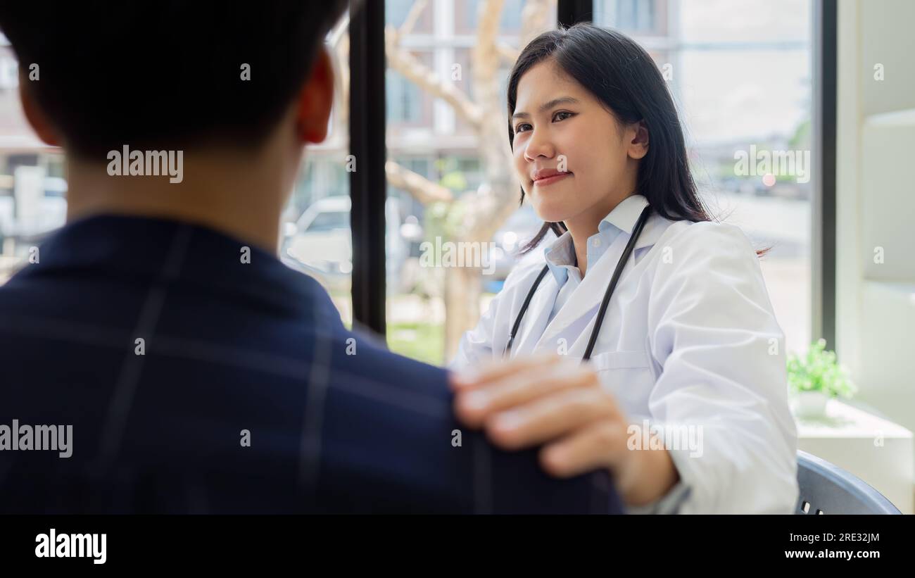 young woman Asian doctor patient, patting shoulder with care, support ...