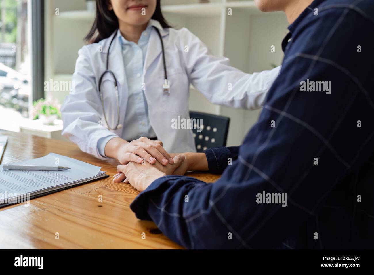 young woman Asian doctor patient, patting shoulder with care, support ...