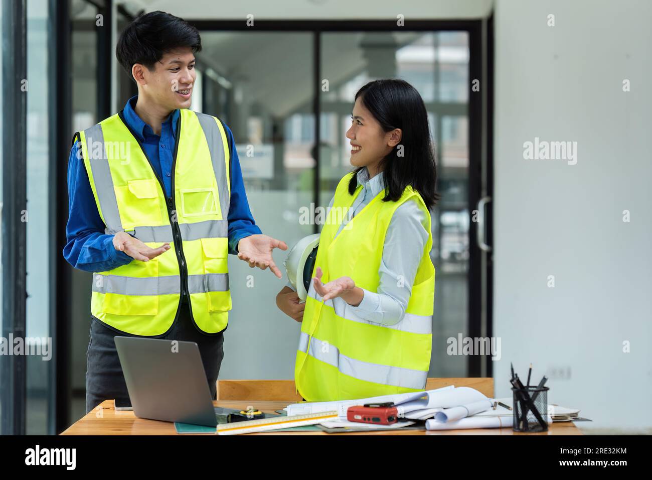 Civil engineers and architects discuss project construction together on ...