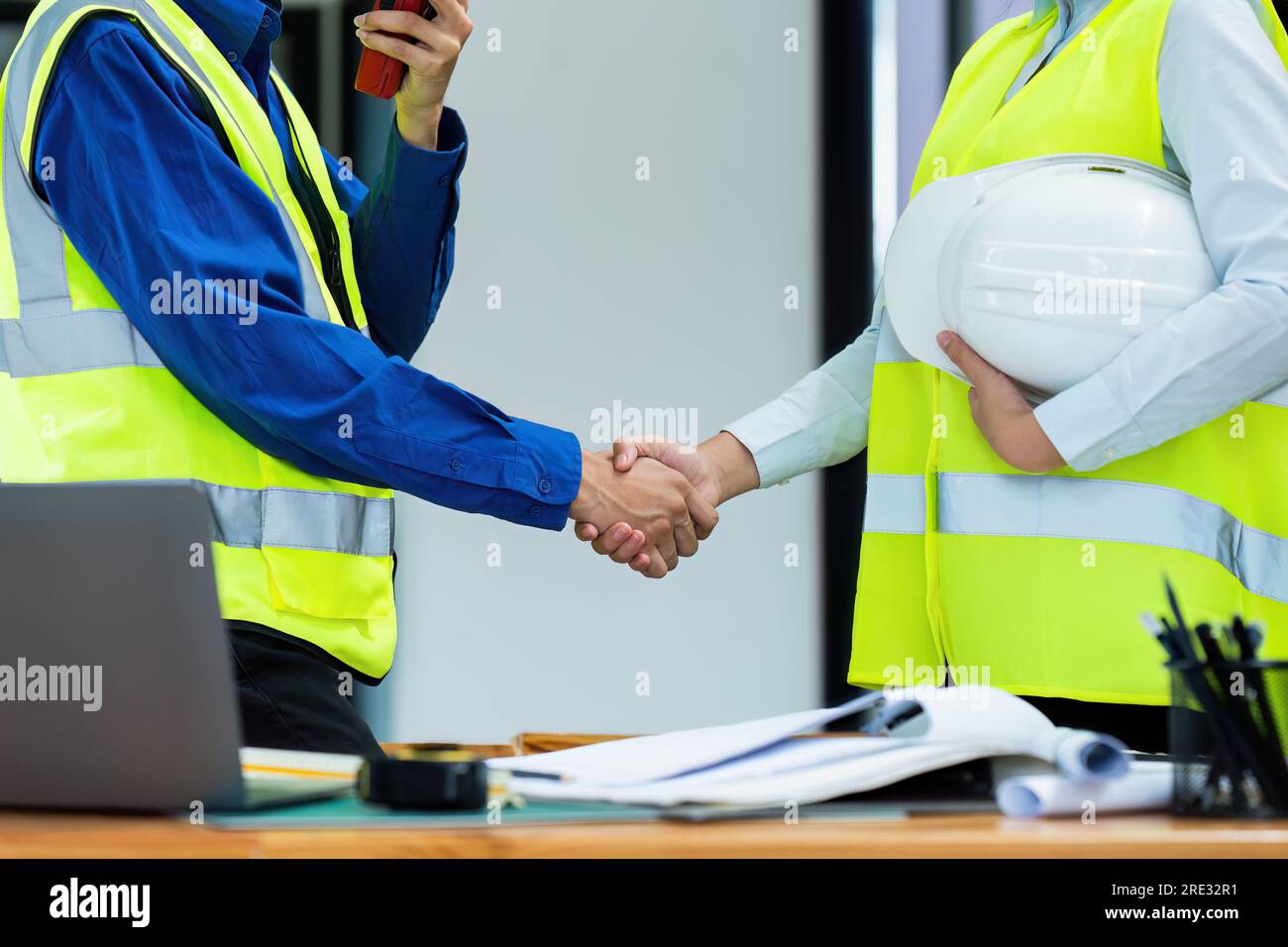 Civil engineers and architects shank hands after work done at office ...