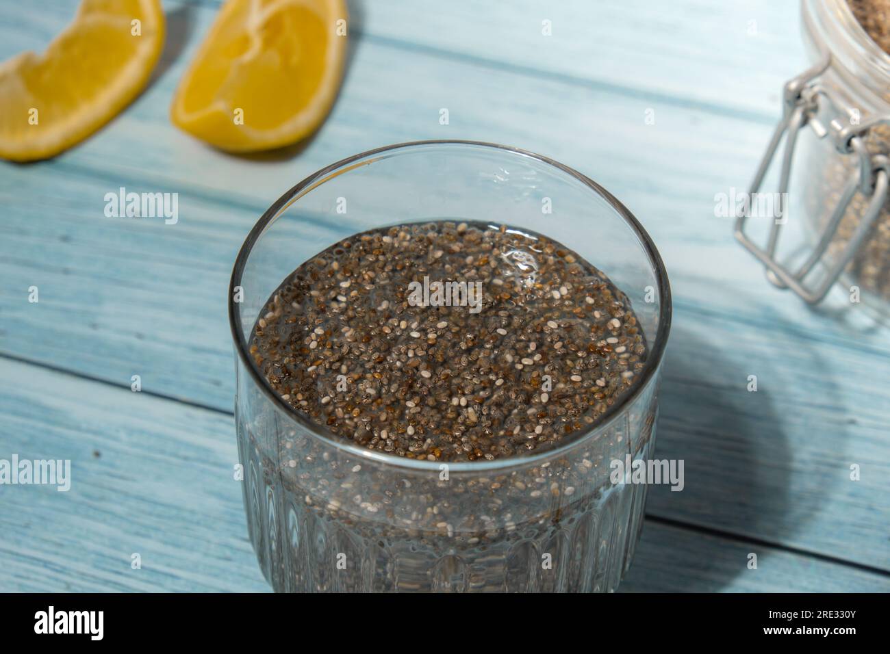 Preparing superfood water drink rich in Omega 3 fatty acids. Pouring ...