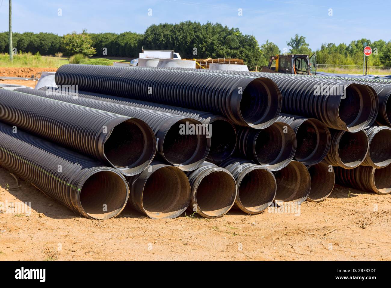 Industrial sewerage pipes made of large black plastic are neatly ...