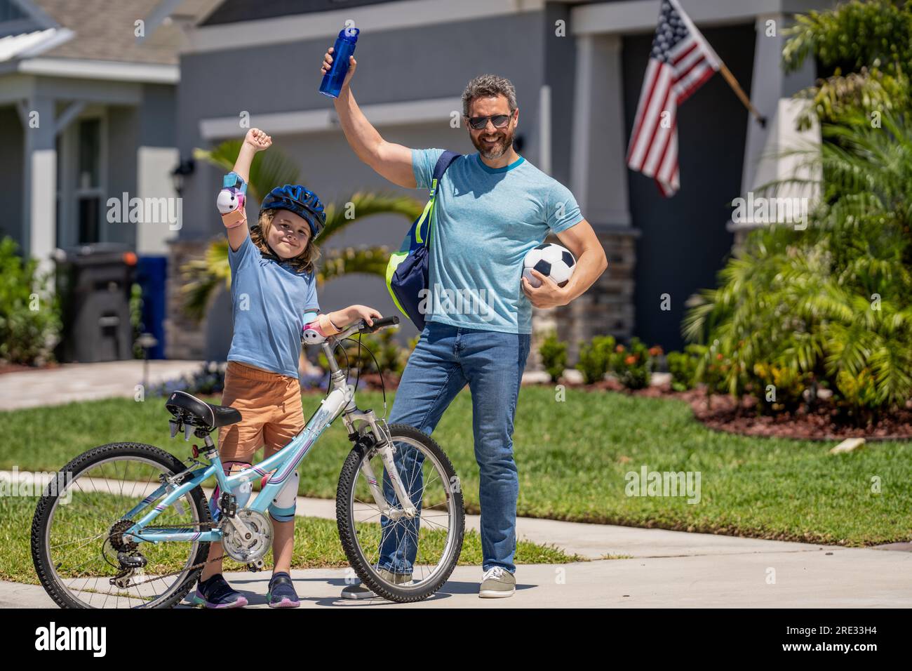 single father guiding son first bike ride. Father and son sharing ...