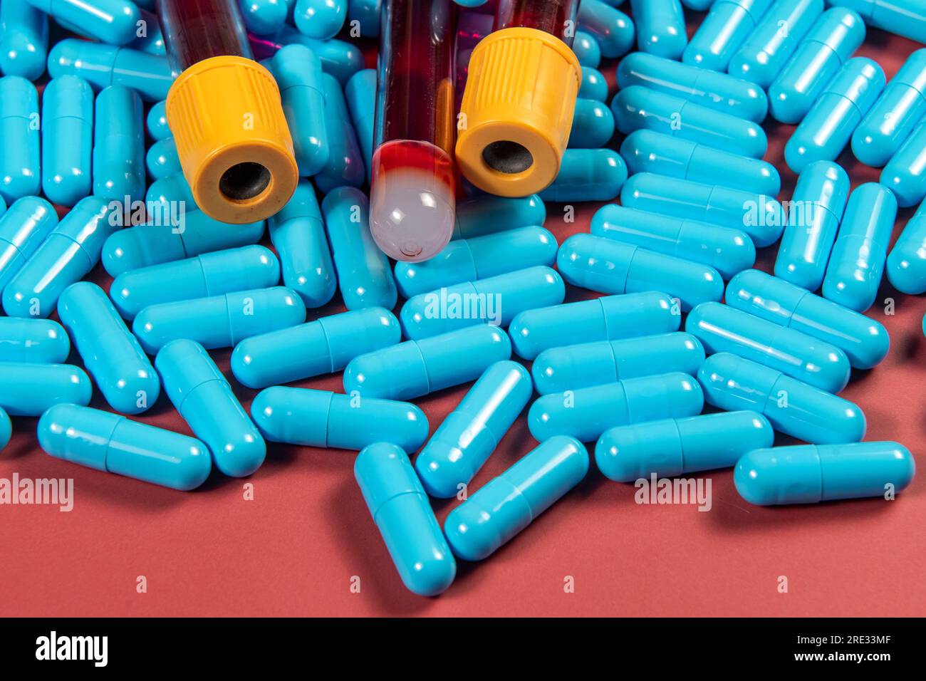 blue medicine capsules and blood test tube symbolizing preventive ...