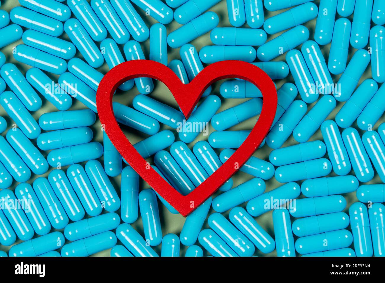 heart shape and blue capsules. Importance of treatment for problems ...