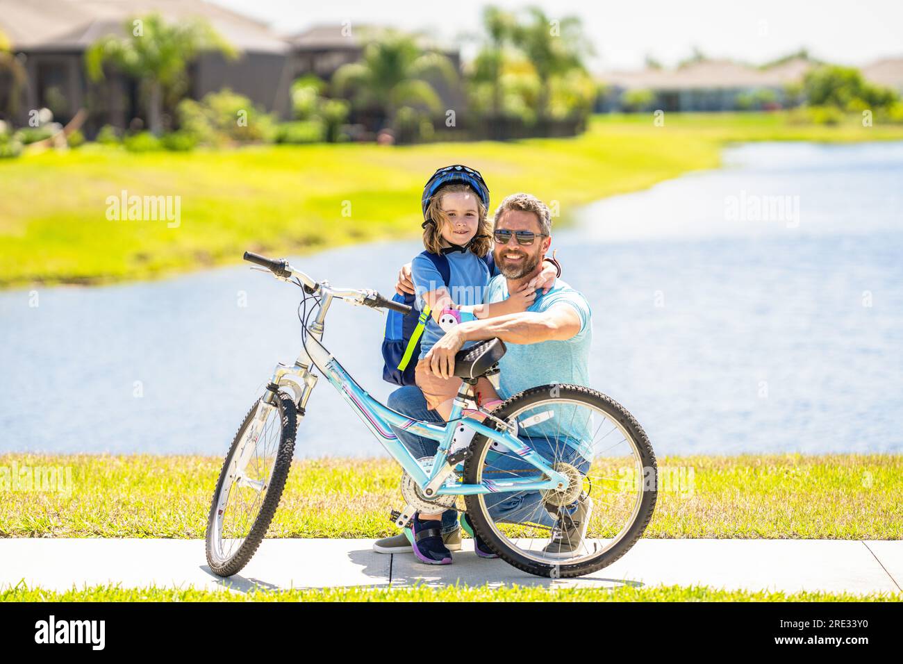 dad hugging son duo pedaling through picturesque landscape. supportive ...