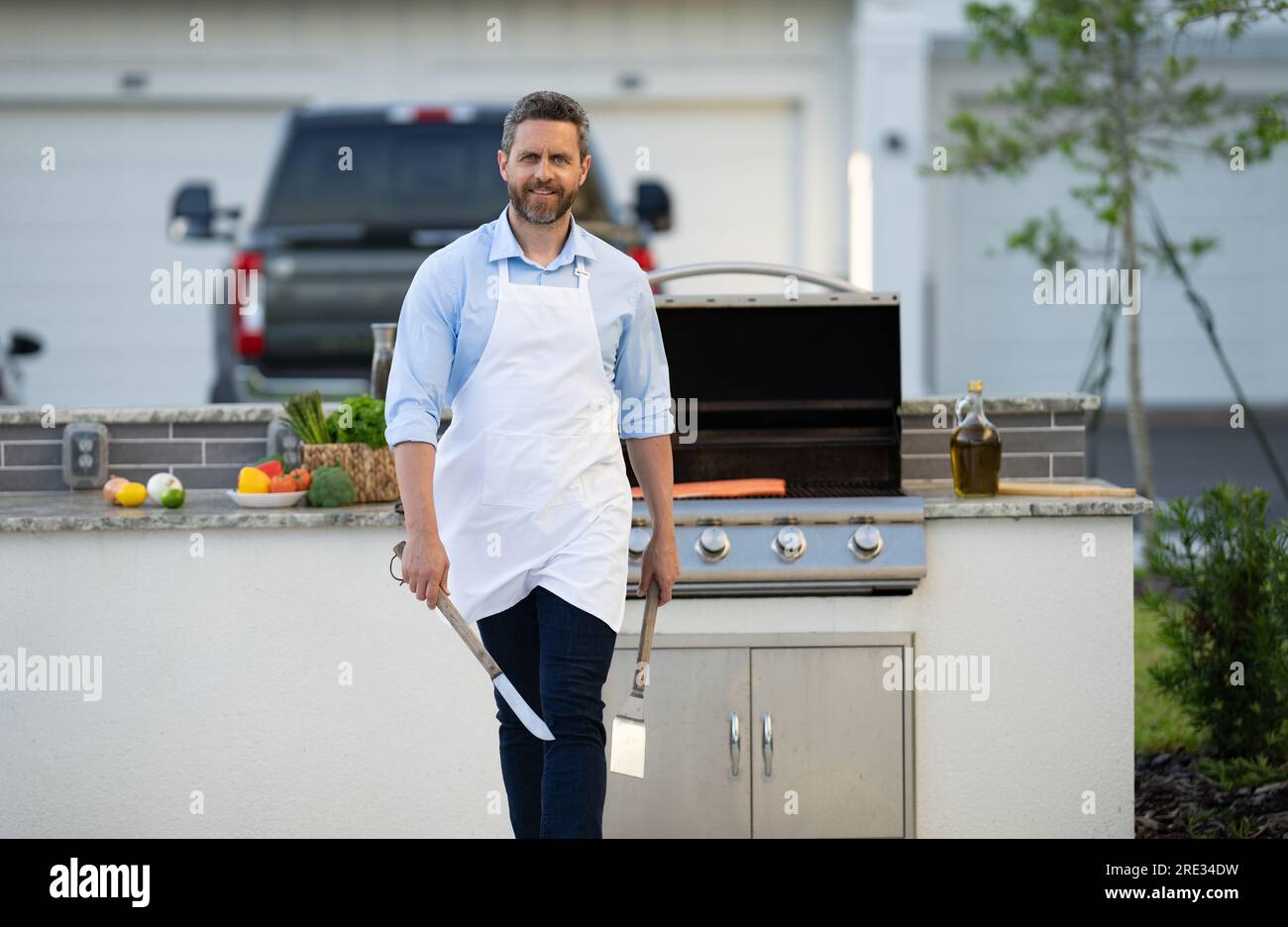 happy man grilling salmon fillet. man grilling salmon fillet outdoor ...