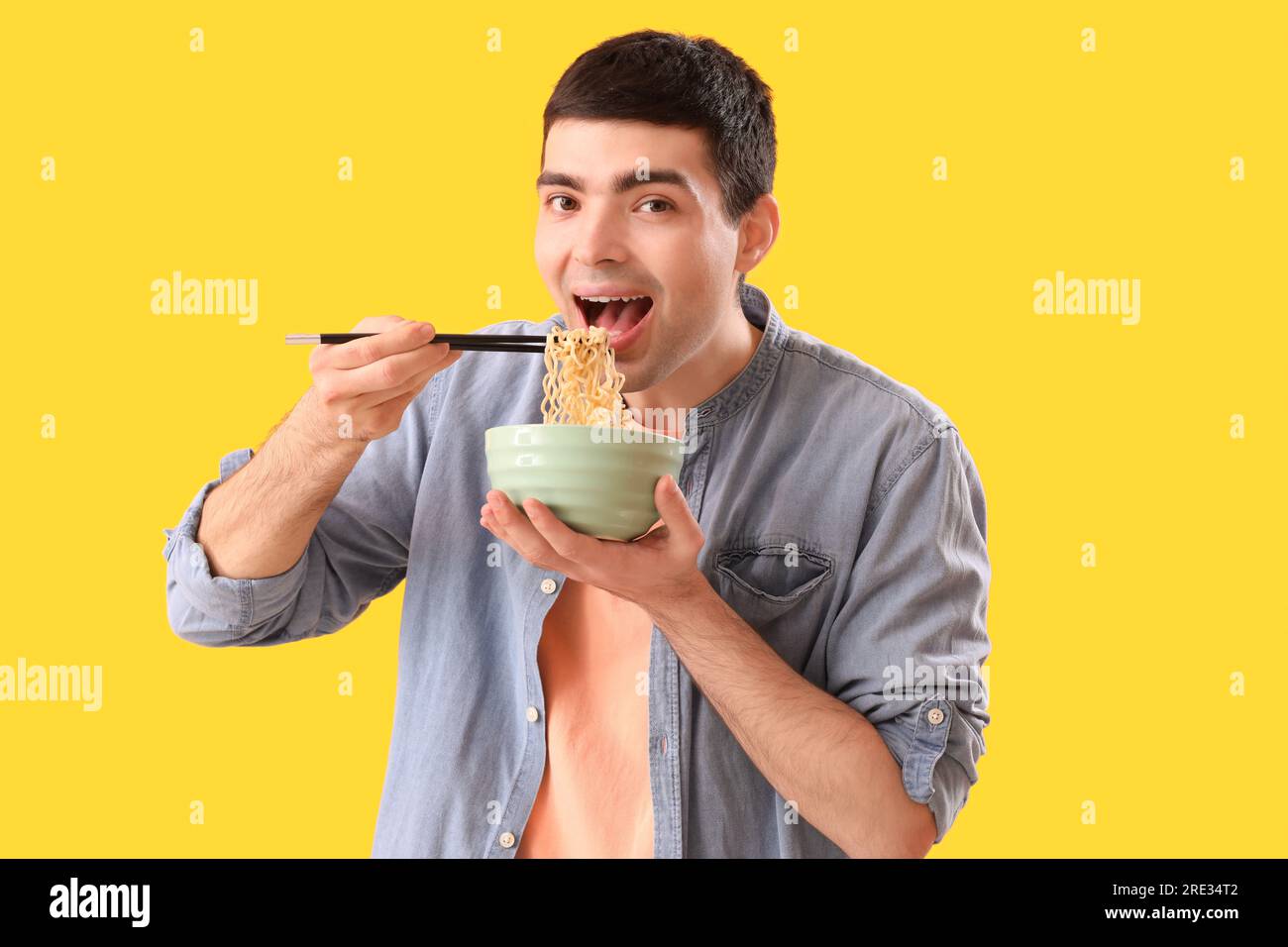 Young male eating ramen noodles hi-res stock photography and images - Alamy