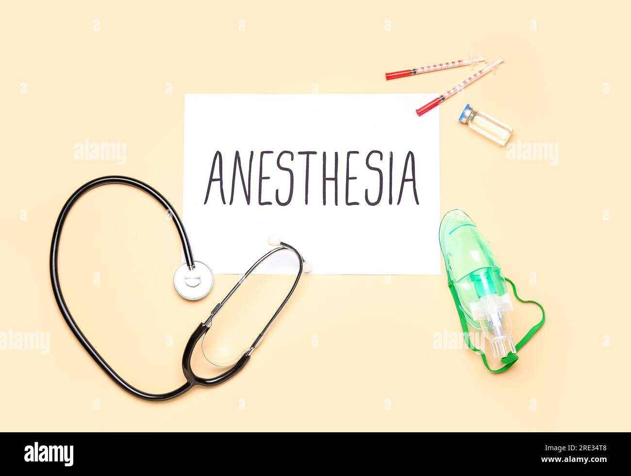 Paper with word ANESTHESIA and medical supplies on beige background ...