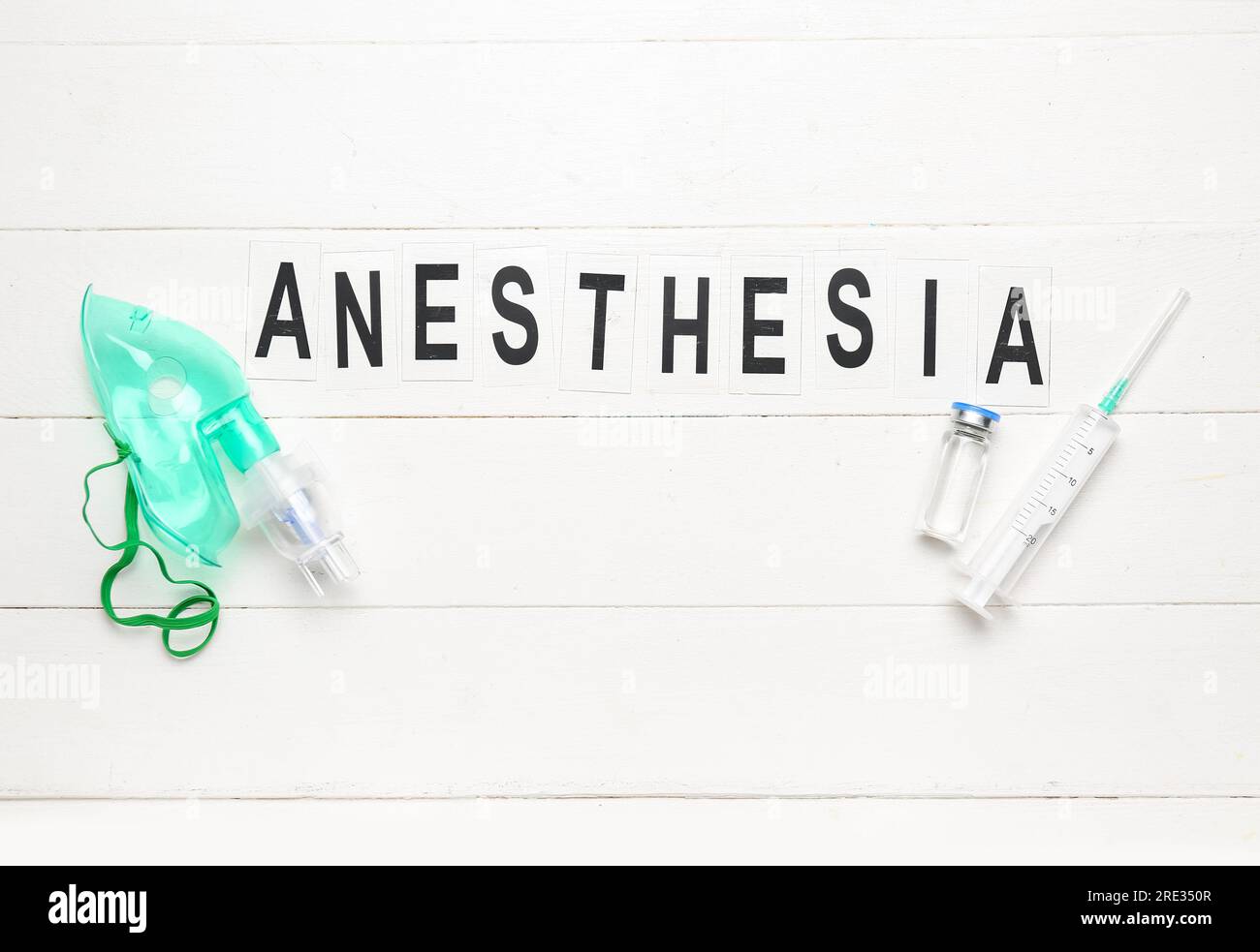 Word ANESTHESIA with oxygen mask, ampule and syringe on white wooden ...