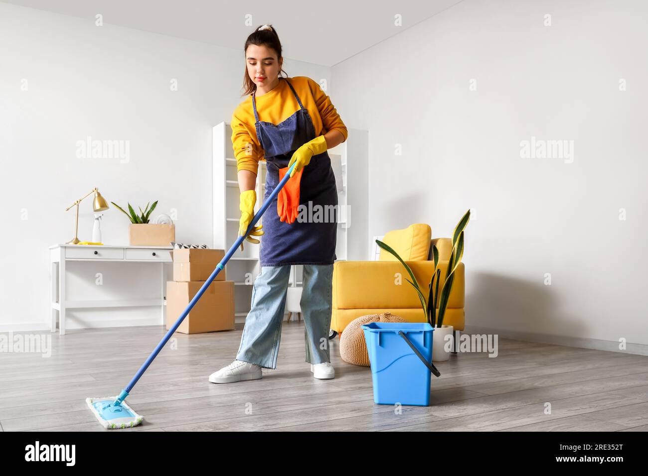 Young woman mopping floor in her house Stock Photo - Alamy