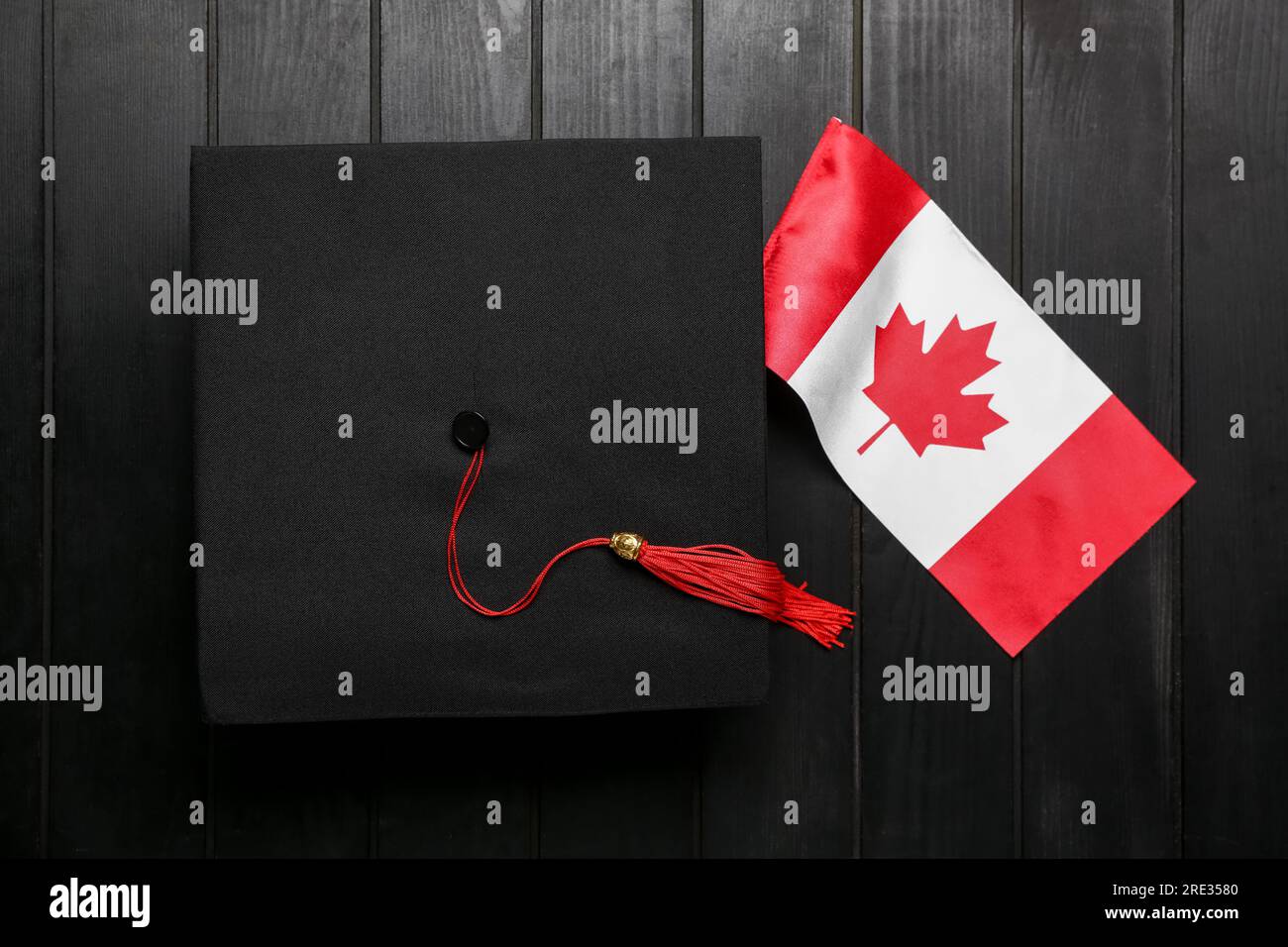 Flag of Canada with graduation hat on dark background Stock Photo - Alamy