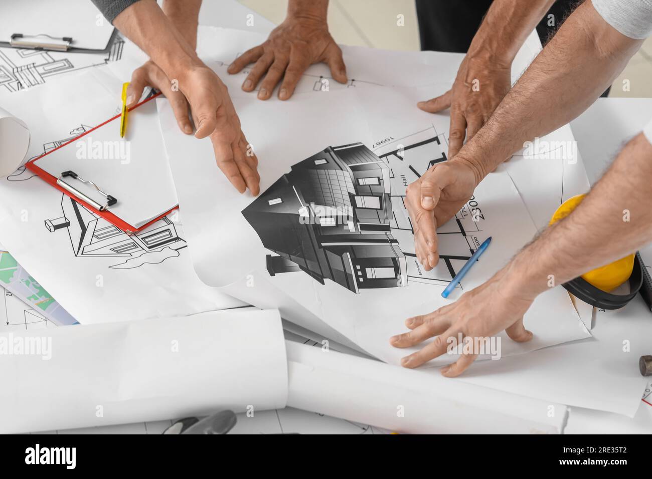 Team of male builders working with house plan in room, closeup Stock ...