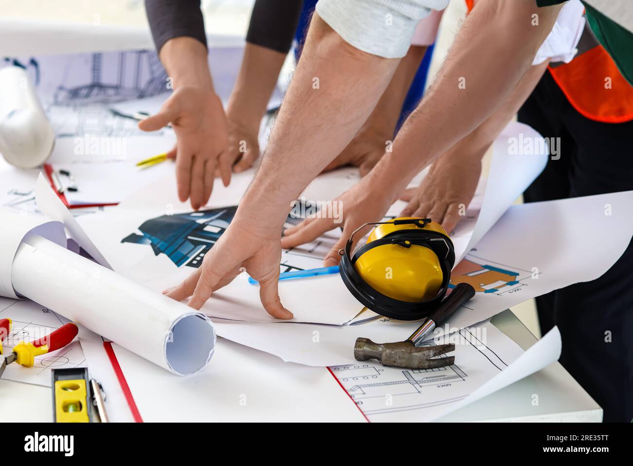 Team of male builders working with house plan in room, closeup Stock ...