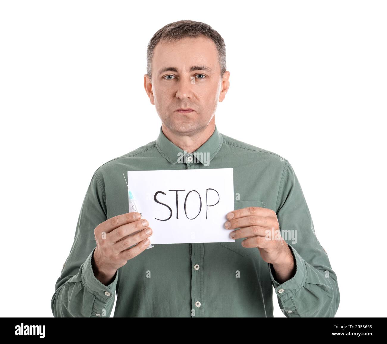 Mature drug addict holding paper with word STOP on white background ...