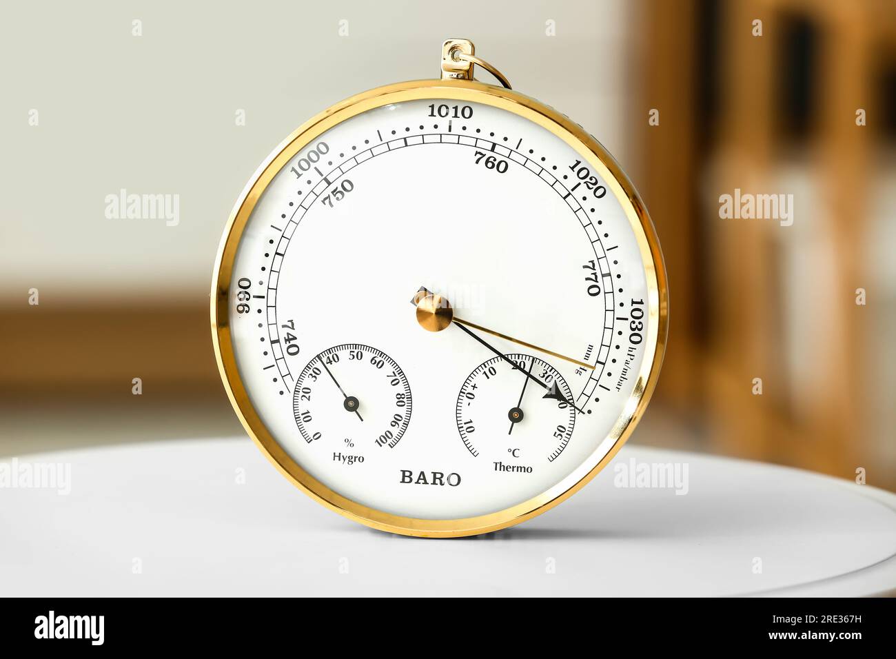 Aneroid barometer on white table in room, closeup Stock Photo - Alamy