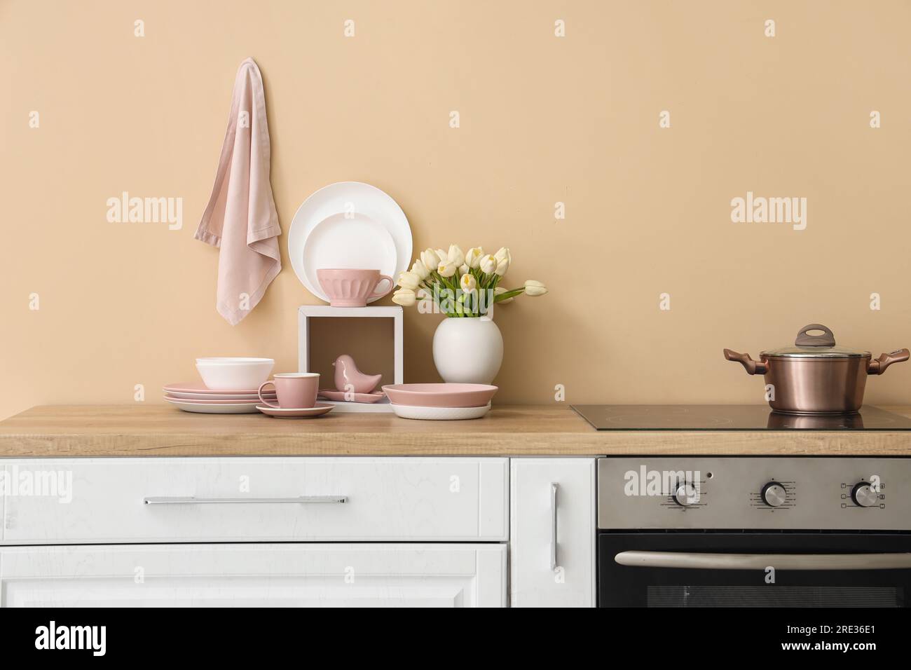 Kitchen counters with clean dishes, oven, electric stove and cooking ...