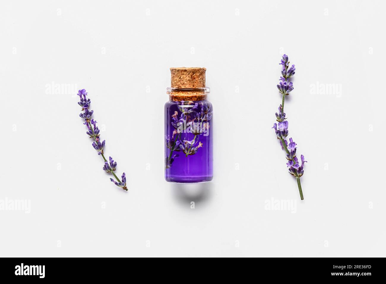 Bottle of essential oil and lavender flowers isolated on white ...