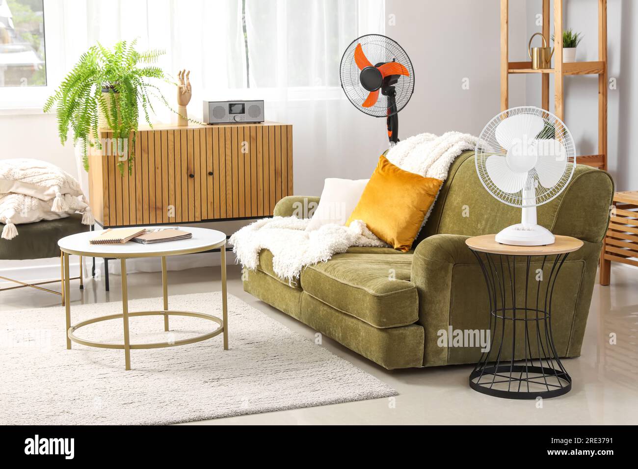 Interior of stylish living room with electric fans and sofa Stock Photo ...