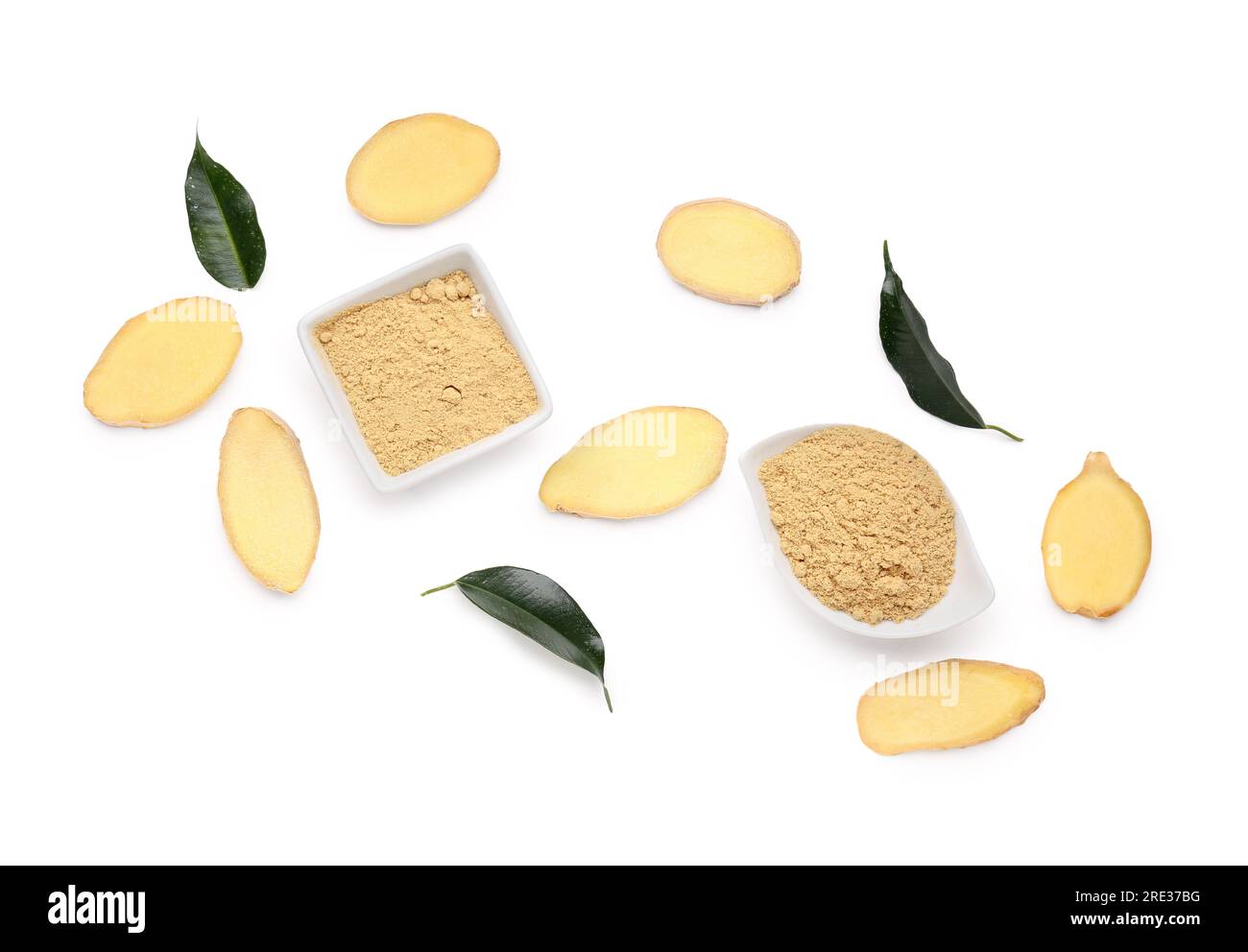 Slices of fresh ginger root and bowls with dried powder on white ...