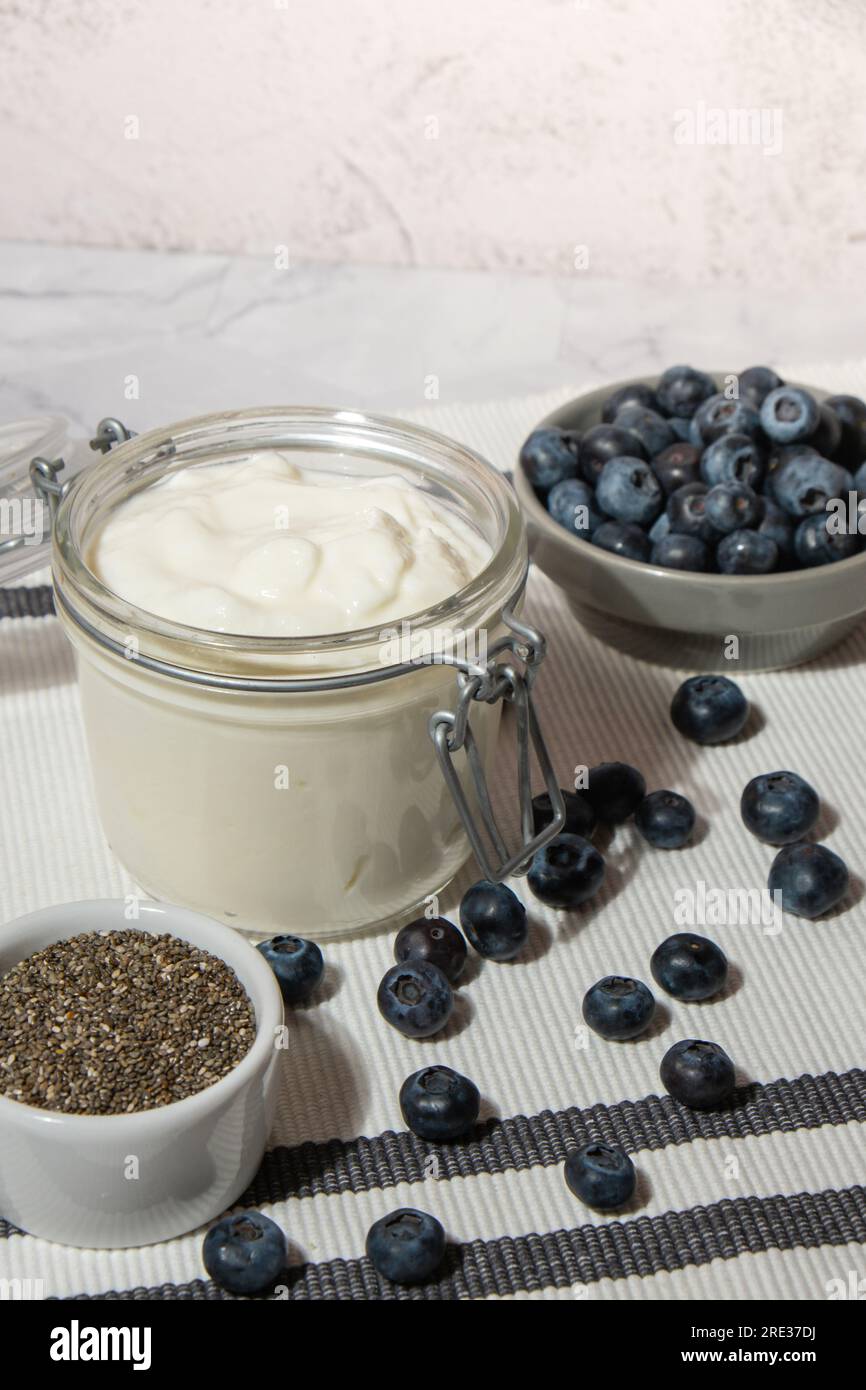 Glass jar with natural organic homemade yogurt and blueberries chia ...