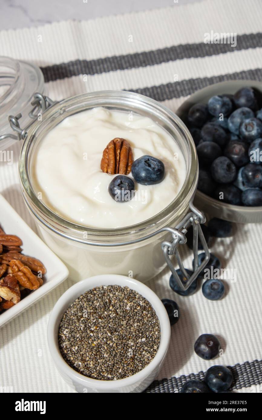 Glass jar with natural organic homemade yogurt and blueberries pecan ...