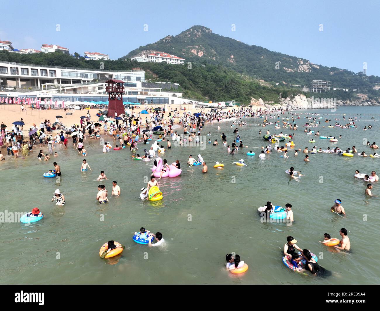 Aerial photo shows tourists swimming in the sea at a bathing beach in ...