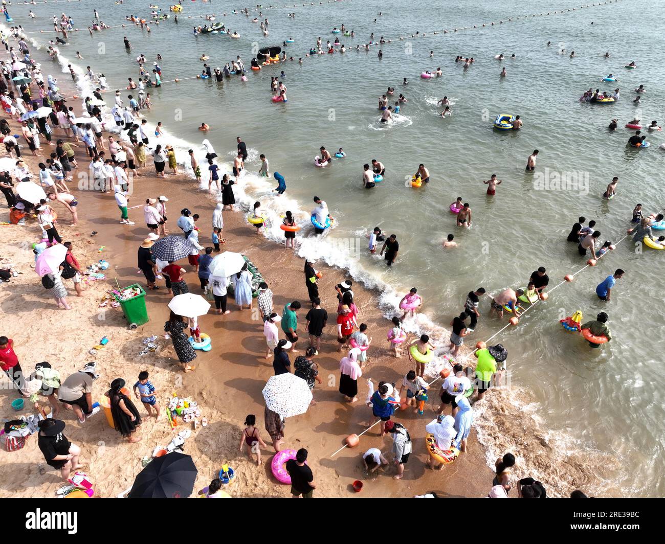 Aerial photo shows tourists swimming in the sea at a bathing beach in ...