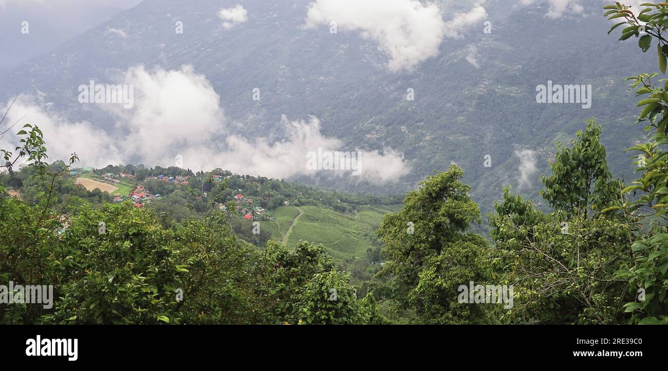 panoramic view of misty and cloudy mountain village surrounded by green ...