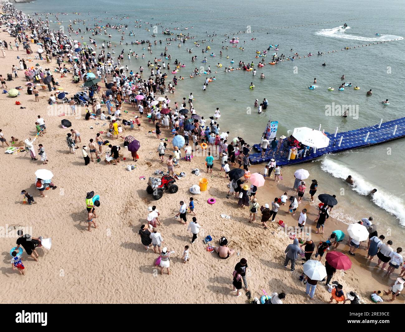 Aerial photo shows tourists swimming in the sea at a bathing beach in ...