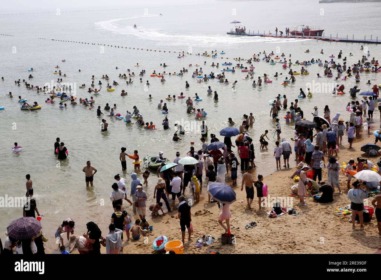 Aerial photo shows tourists swimming in the sea at a bathing beach in ...