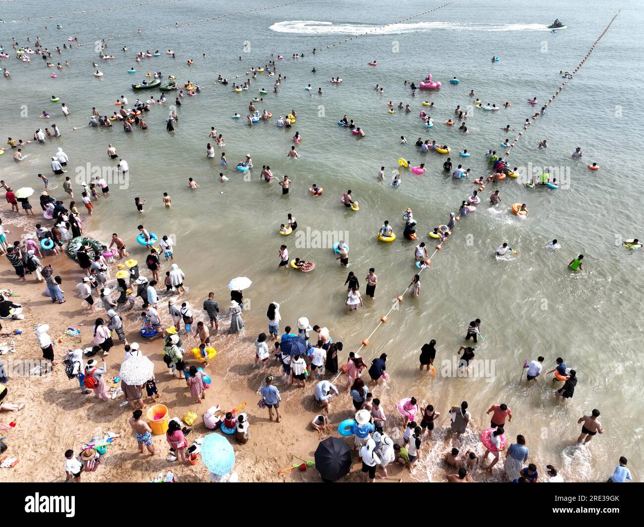 Aerial photo shows tourists swimming in the sea at a bathing beach in ...