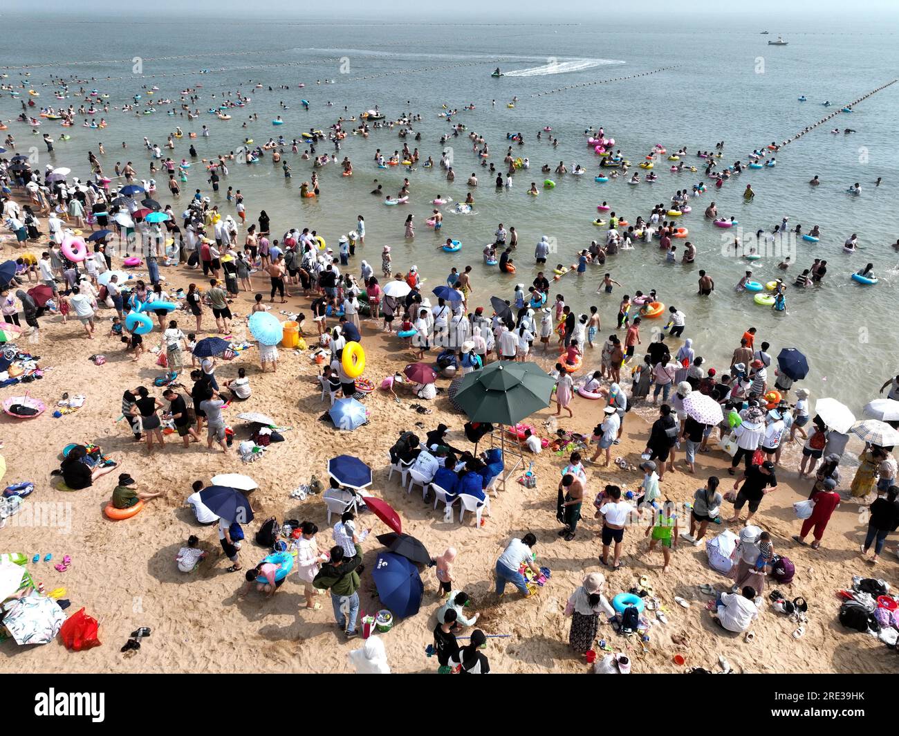 Aerial photo shows tourists swimming in the sea at a bathing beach in ...