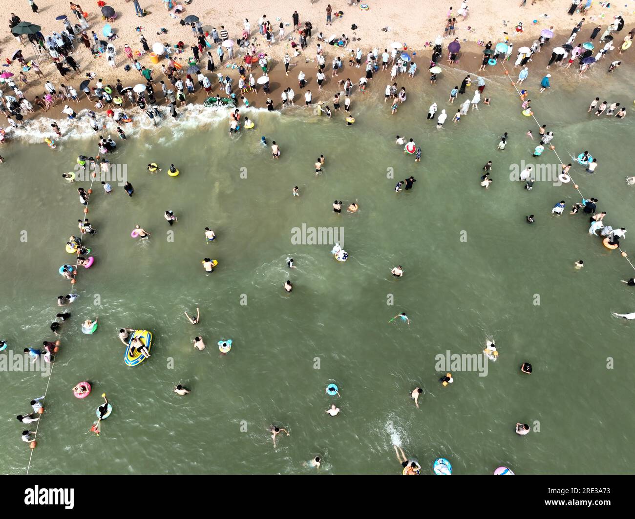 Aerial photo shows tourists swimming in the sea at a bathing beach in ...