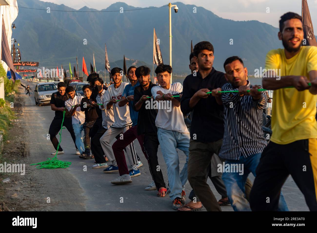 Srinagar, India. 24th July, 2023. Shia Muslims pull ropes tied to an ...