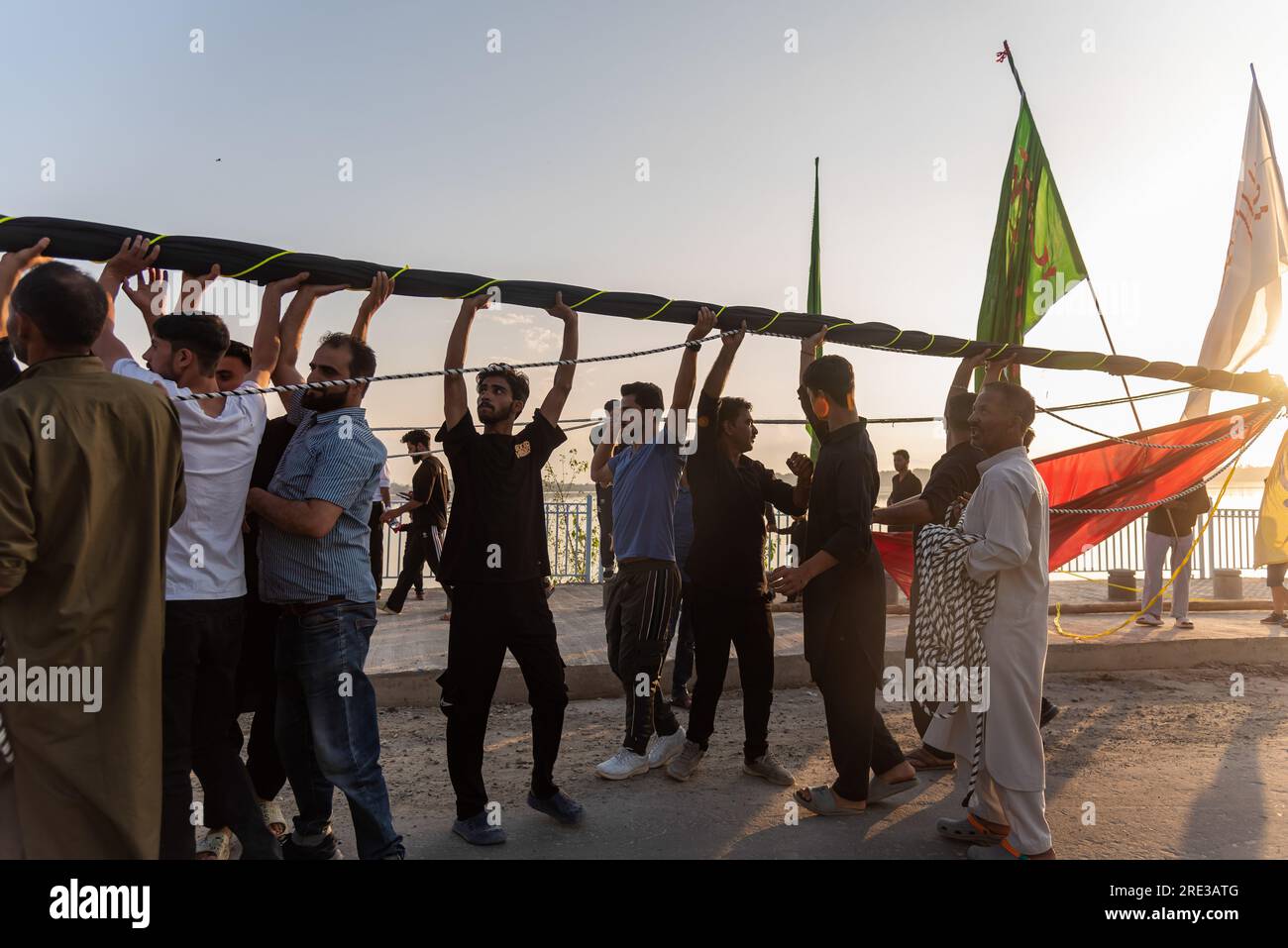 Srinagar, India. 24th July, 2023. Shia Muslims hold an Alam (Islamic ...