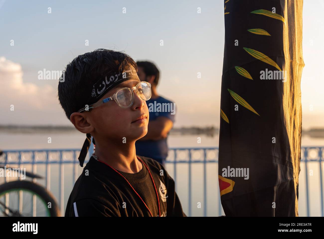 Srinagar, India. 24th July, 2023. A Shia boy holding an Islamic flag ...