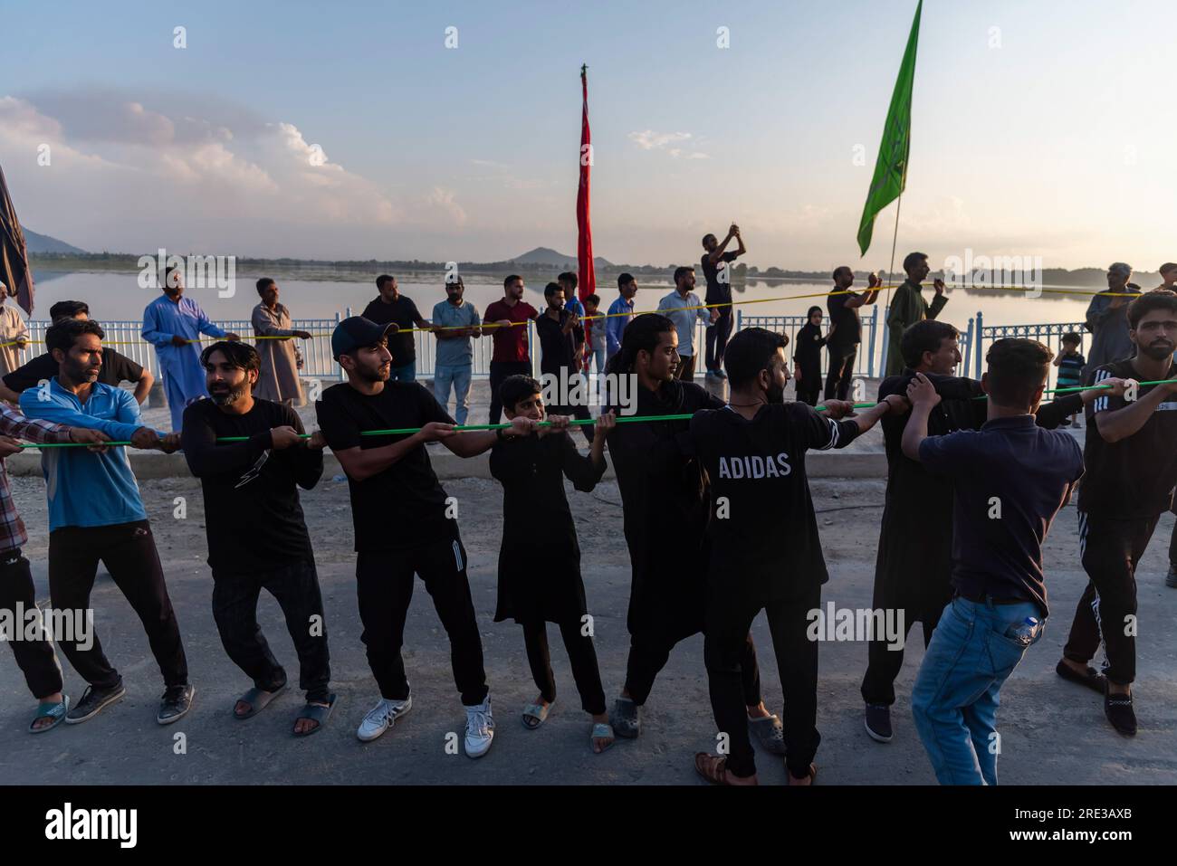 Srinagar, India. 24th July, 2023. Shia Muslims pull ropes tied to an ...