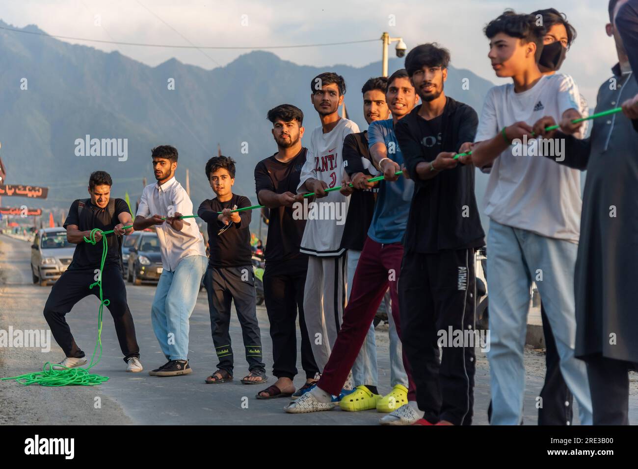 Srinagar, India. 24th July, 2023. Shia Muslims pull ropes tied to an ...