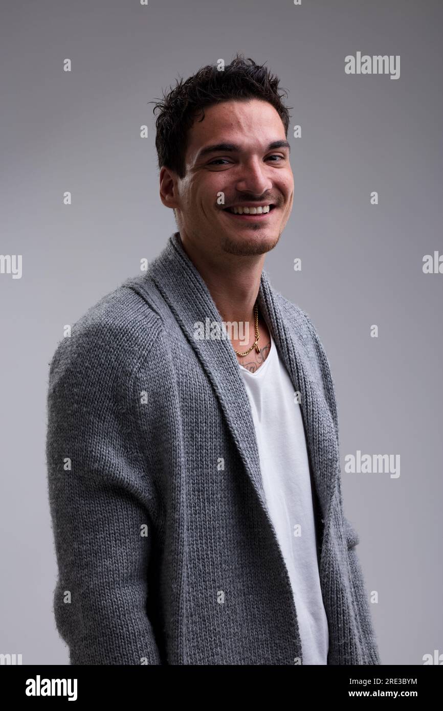 Smiling young man, attractive, tall, with black hair and slight facial ...