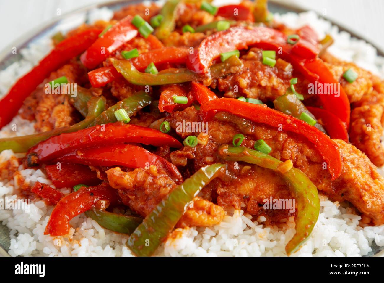Homemade Simple Chili Chicken with White Rice on a Plate, side view ...