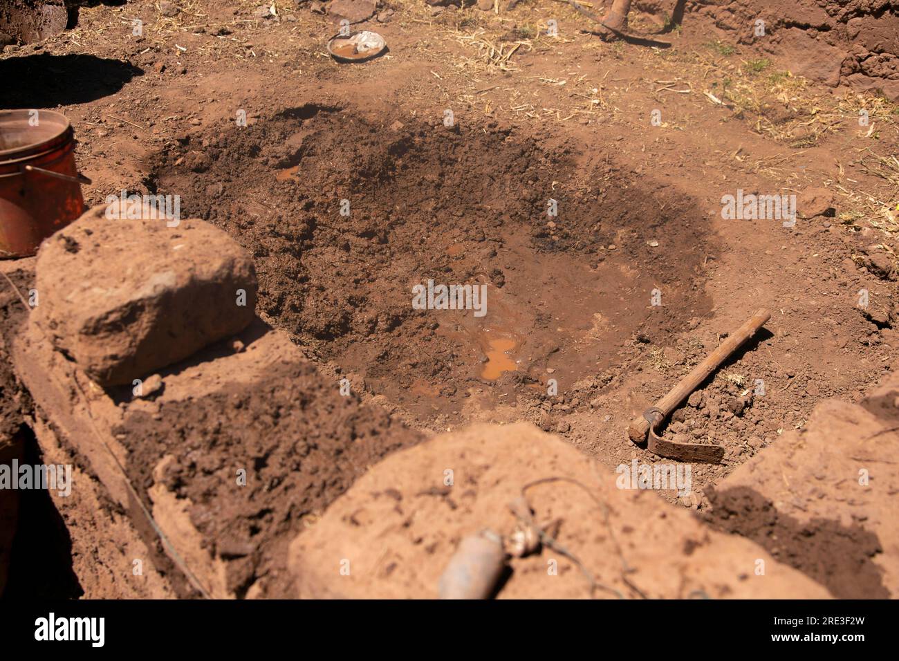 Man building with his hands an adobe house with adobe bricks and mud ...