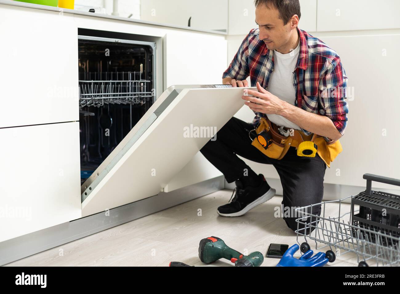 Male Technician Examining Dishwasher With Digital Multimeter Stock ...