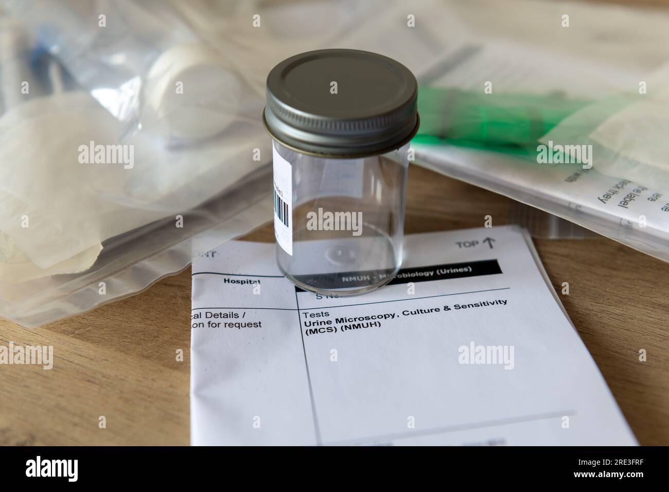 A sample container and a medical form for a Urine Microscopy test Stock ...