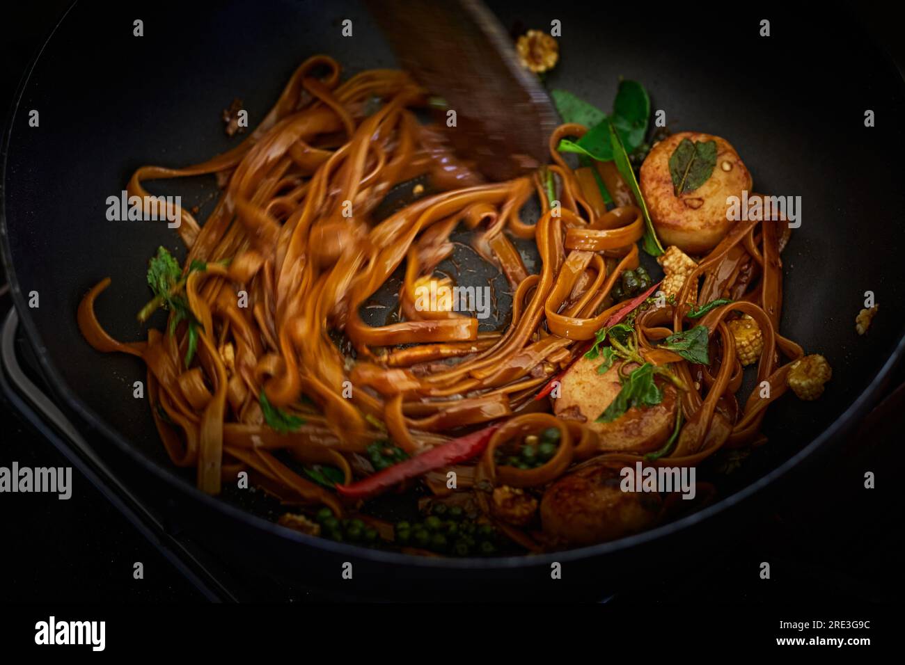 Stir frying Spicy pasta with Scallop in wok,selective focus Stock Photo ...