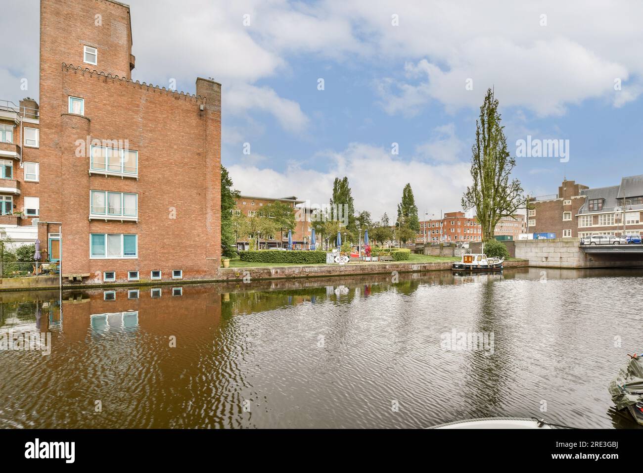 a boat in the water with buildings on either side and blue sky above it ...