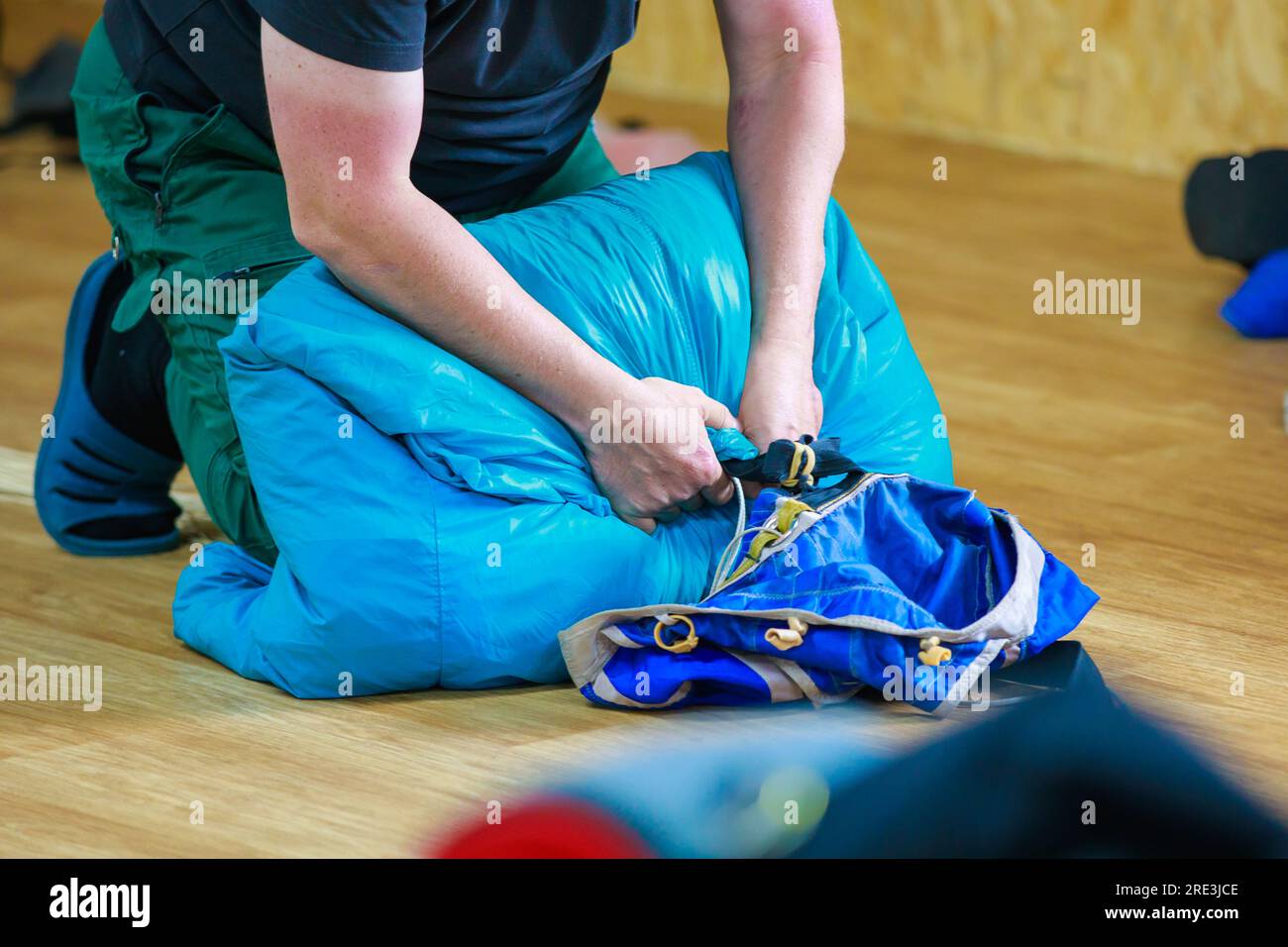 Packing a parachute into a backpack. High quality photo Stock Photo - Alamy